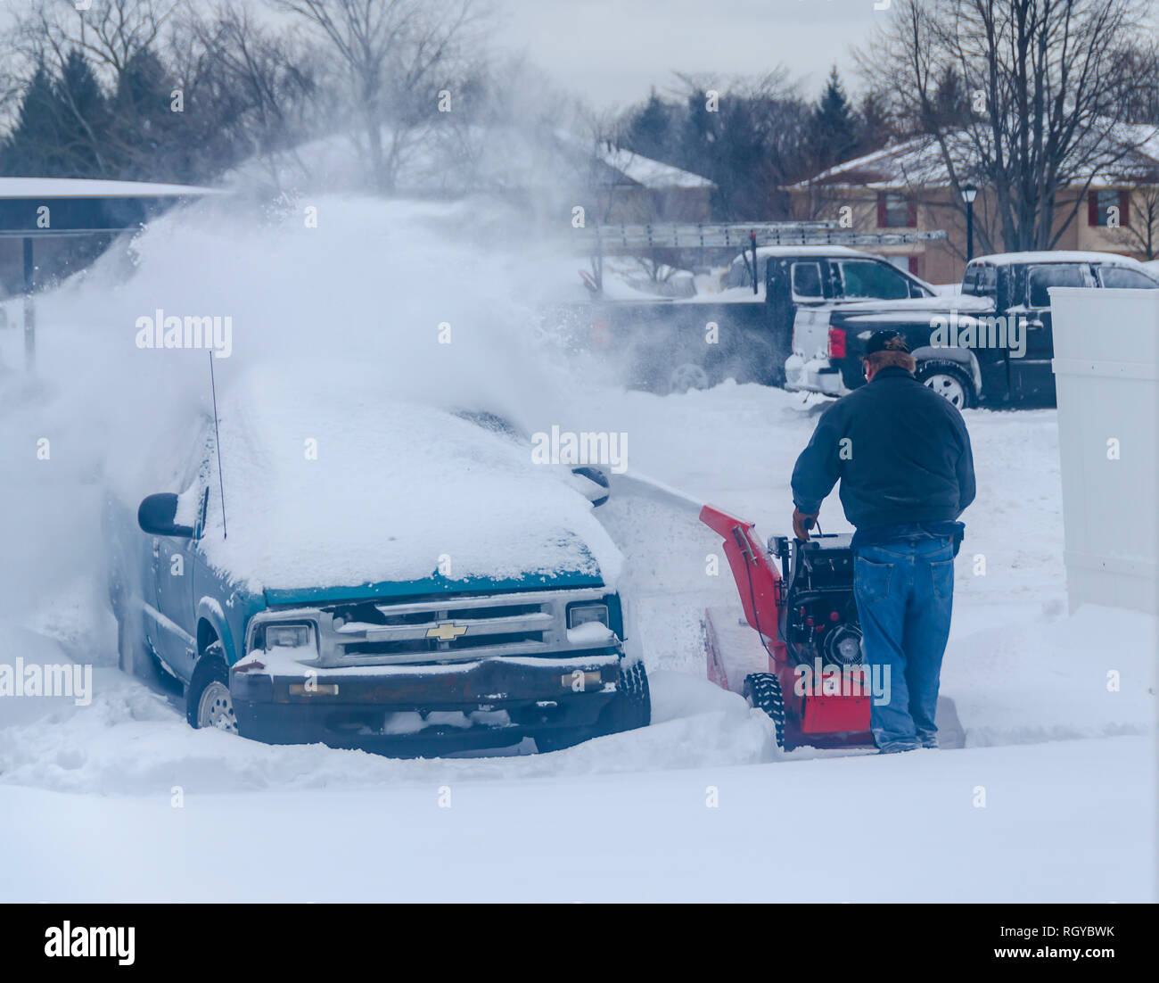 Extreme winter snowfall! A man clearing snow from a residential street ...