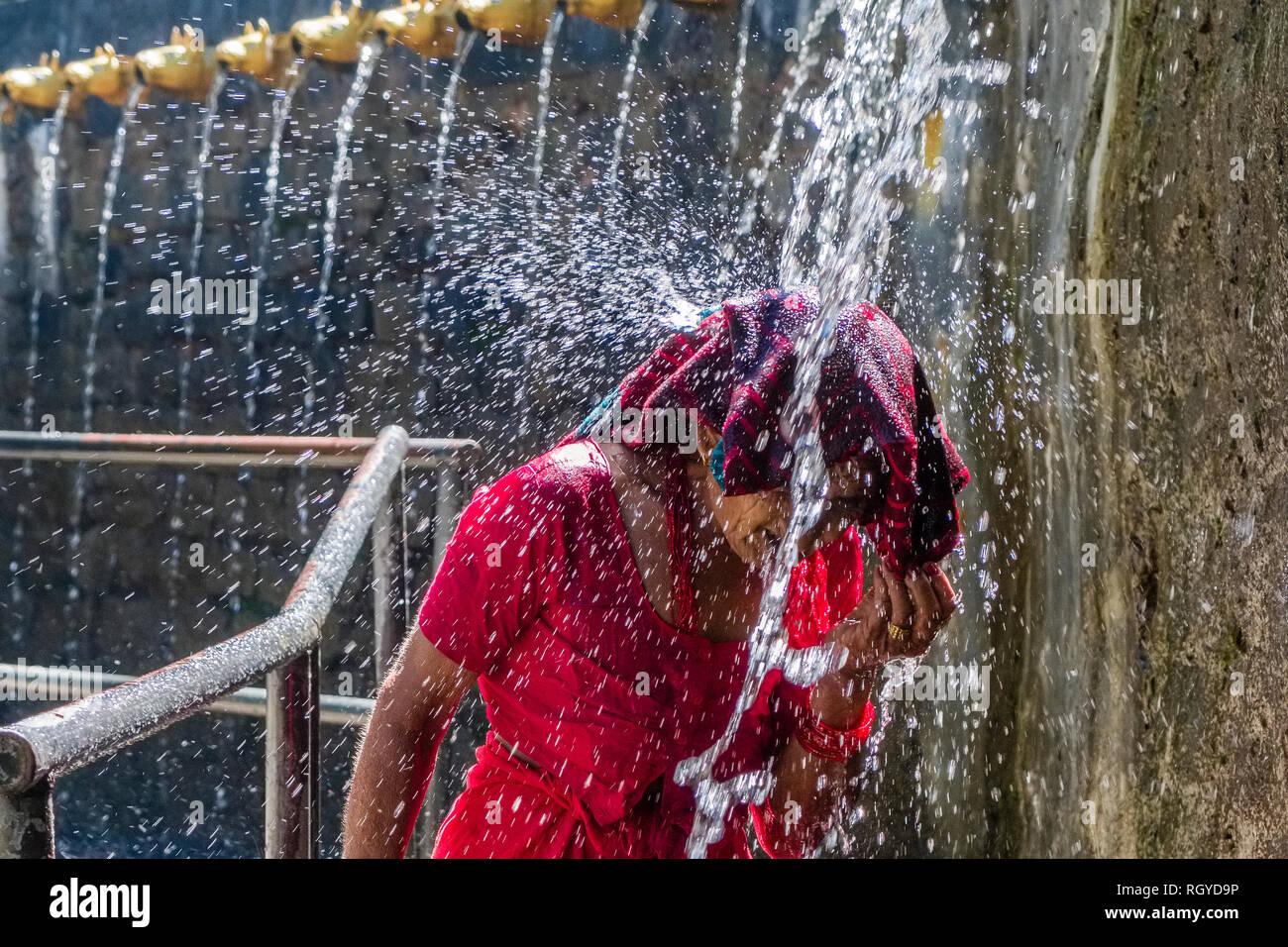 Pilgrim taking shower at the 108 wells spending ice cold holy water in ...