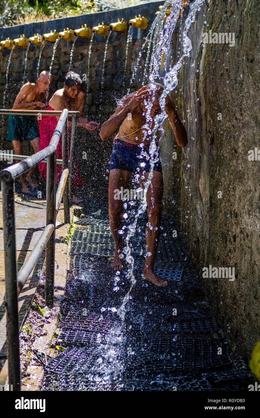 Pilgrim taking shower at the 108 wells spending ice cold holy water in ...