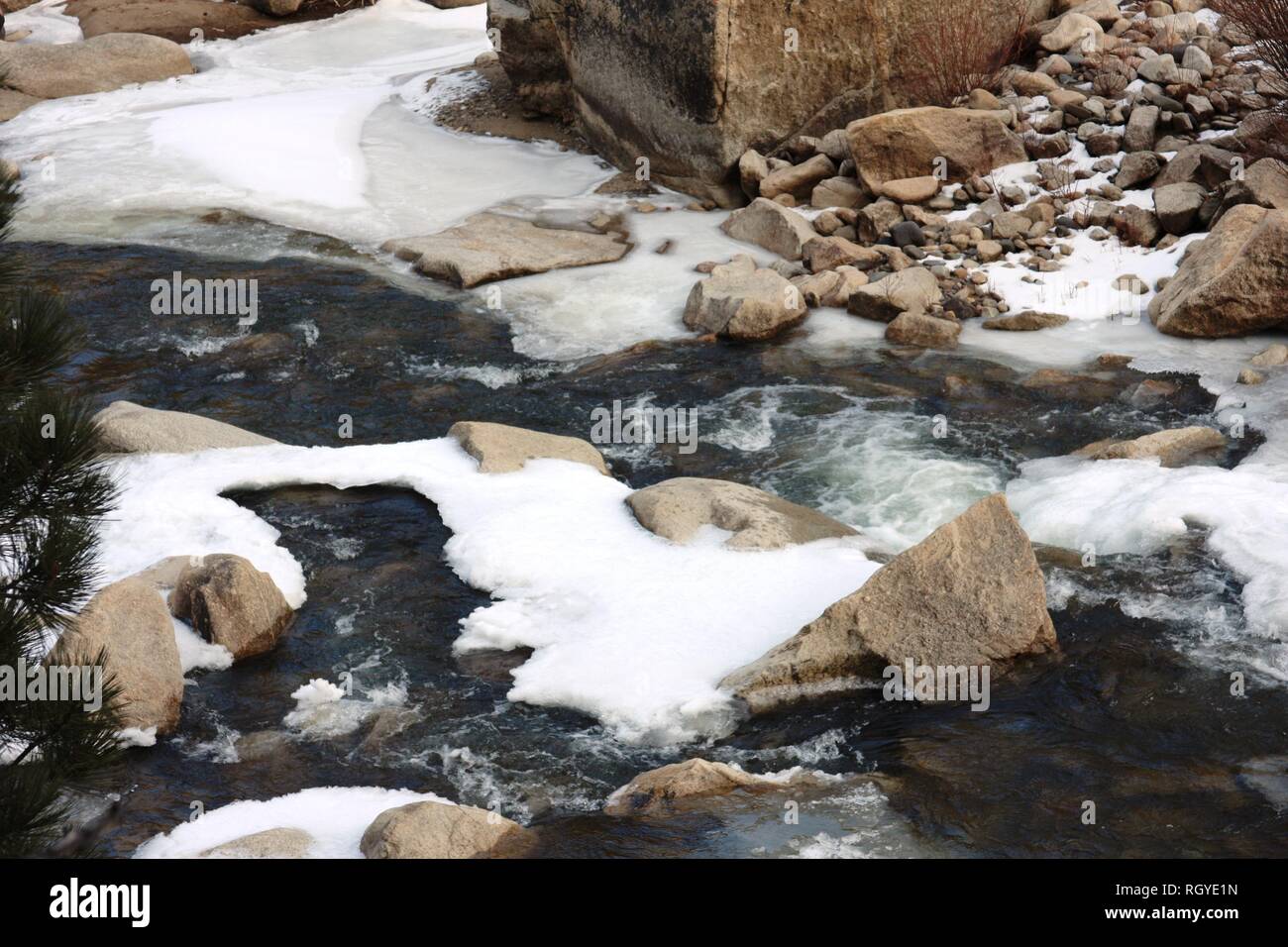 Snow covered stream Stock Photo - Alamy