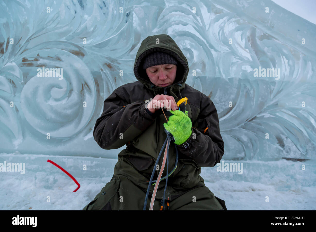 Electrician isolates the ends of the power cable to illuminate the ice ...
