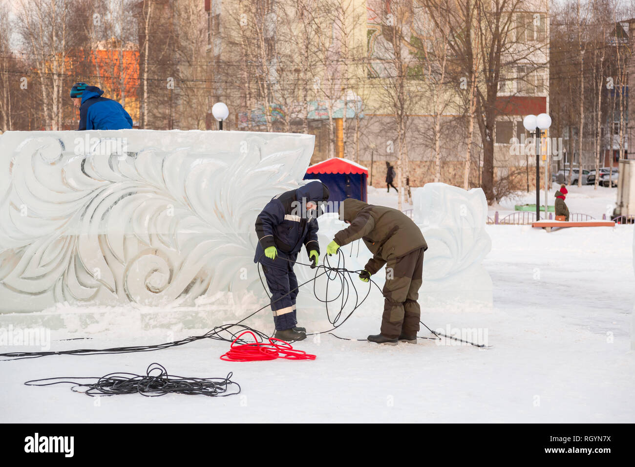 Electricians mount a power cable to illuminate ice figures Stock Photo ...