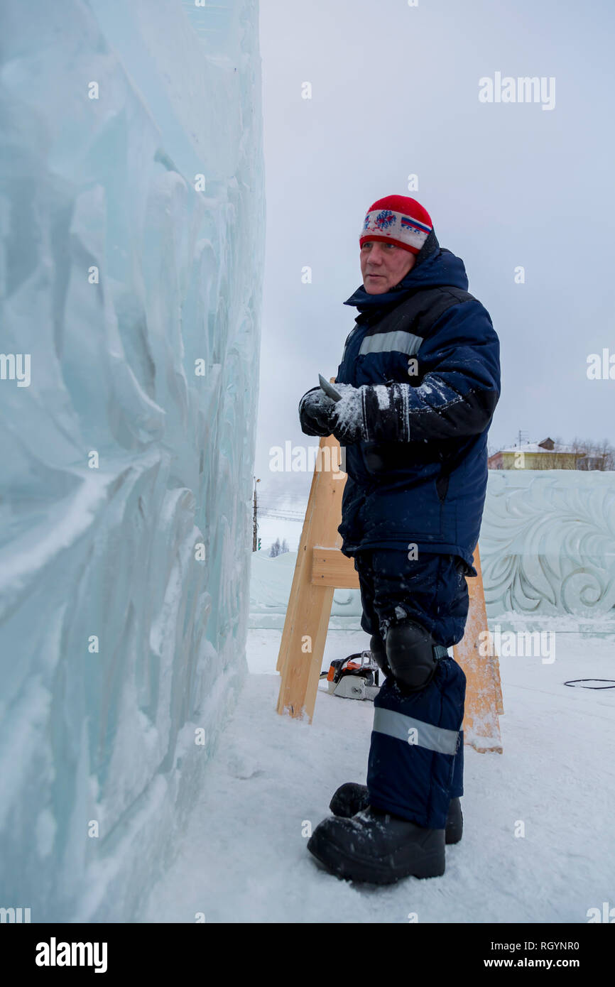 The sculptor cuts an ice figure out of a block of ice for Christmas ...