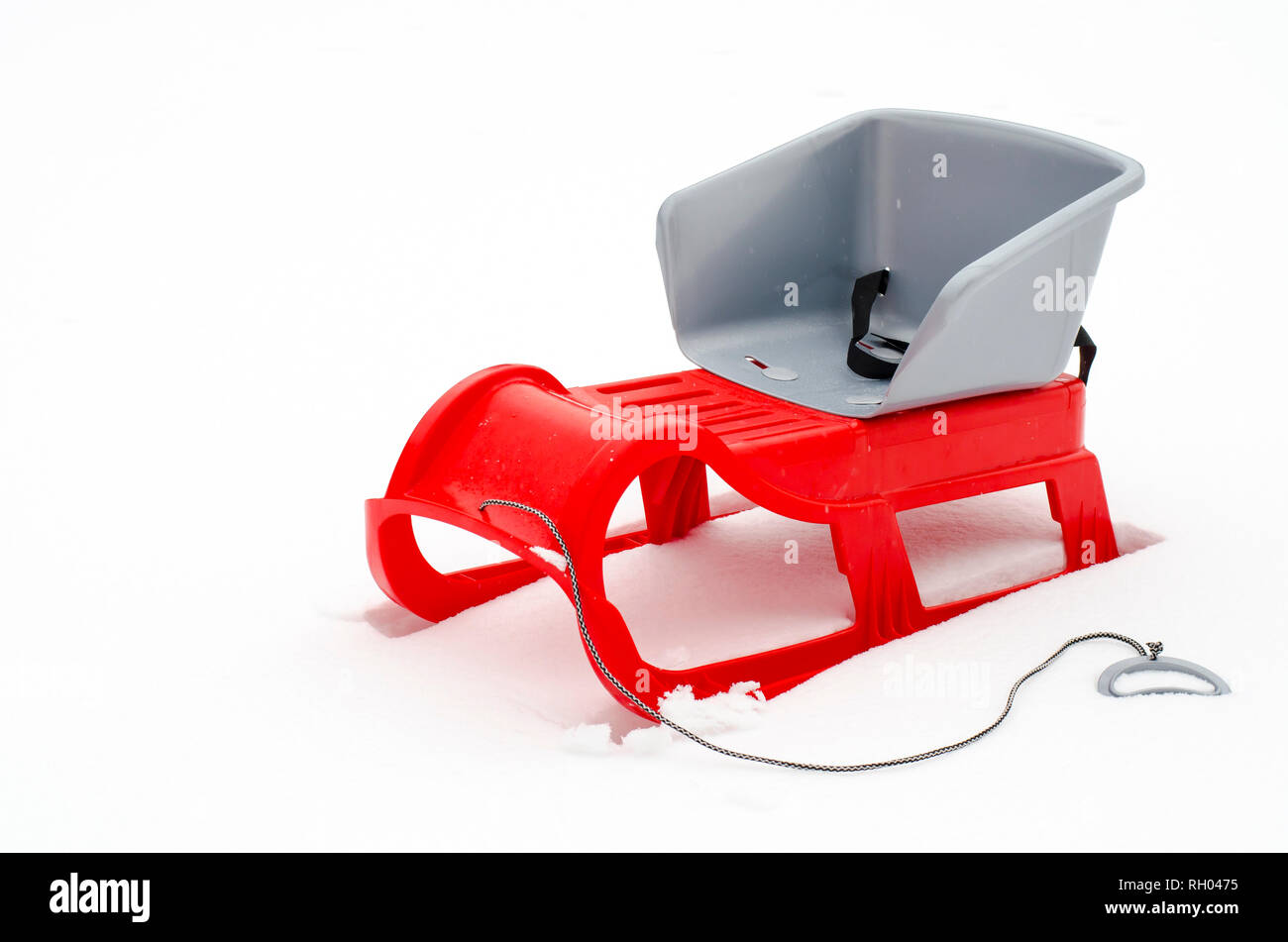 Red children sledges on white snow background. Studio Photo Stock Photo ...