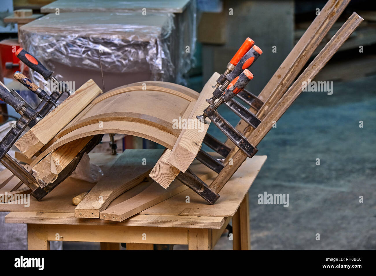 Production of curved MDF cabinet doors. Metal clamps tightening mdf ...