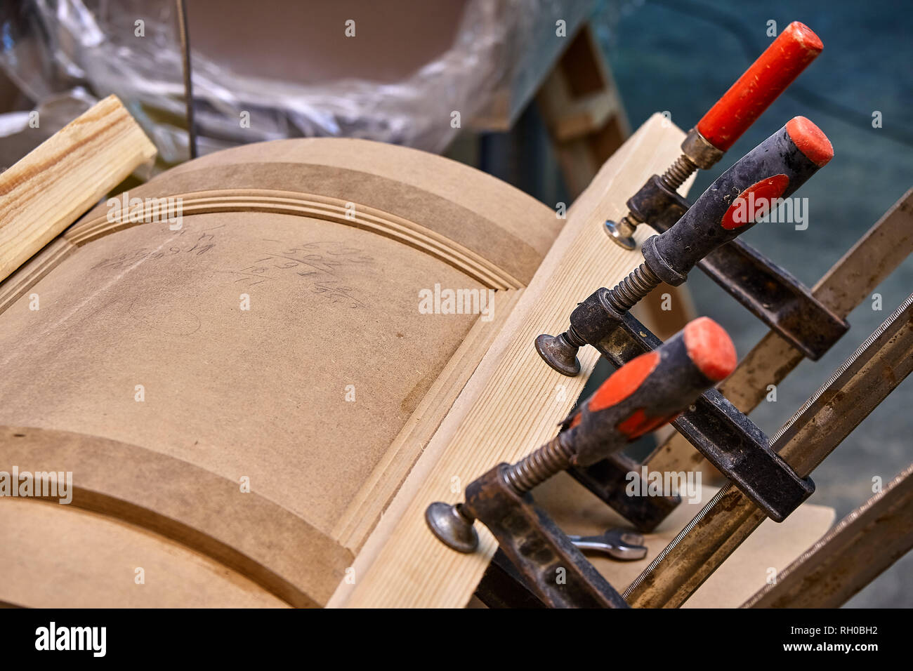 Production of curved MDF cabinet doors. Metal clamps tightening mdf ...
