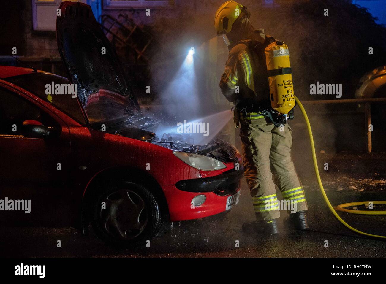 Fire and Rescue are seen putting the fire out on the car. A car caught ...