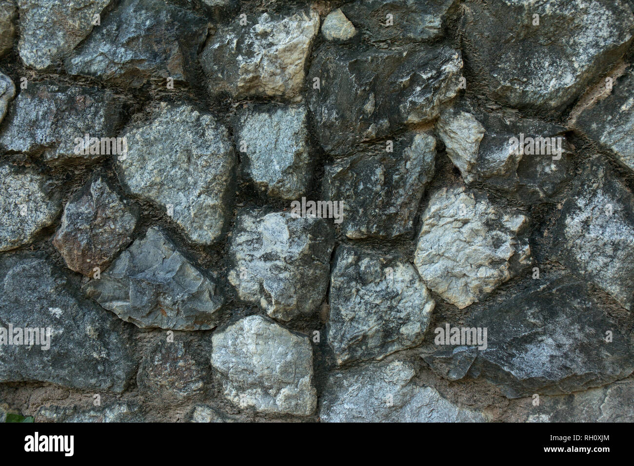 Old rough stone wall. Rock gray background Stock Photo - Alamy
