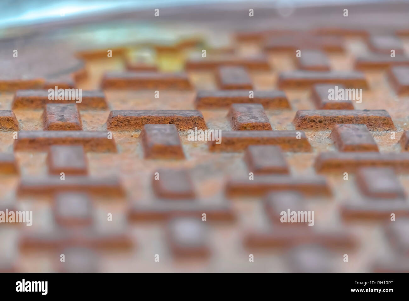 Detail of a round and rusty manhole cover Stock Photo - Alamy