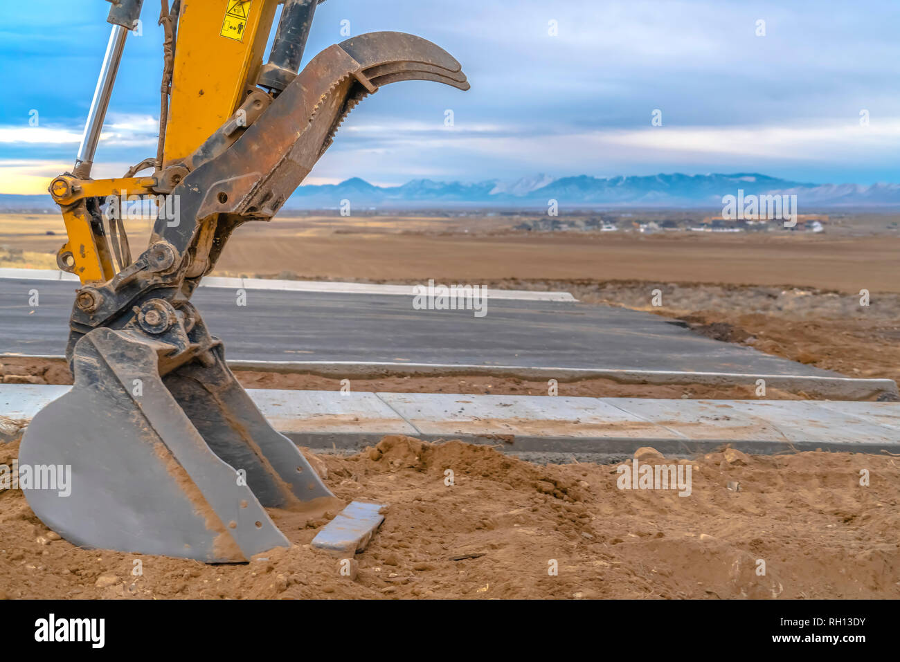 Excavator bucket with view of mountain and sky Stock Photo - Alamy