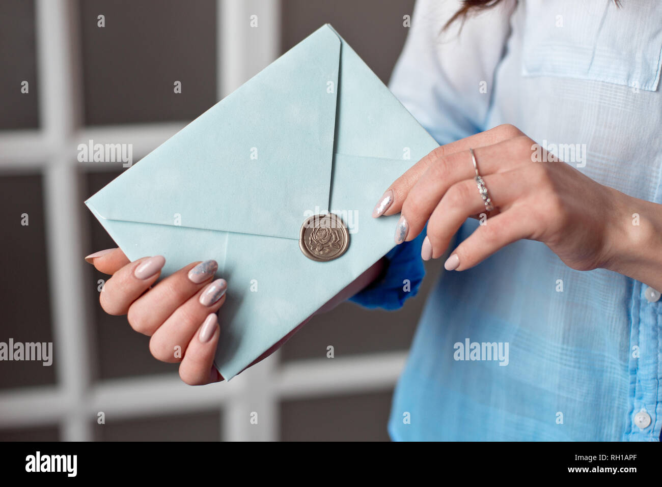 Close-up of a woman with a slim body holding a blue rectangular ...