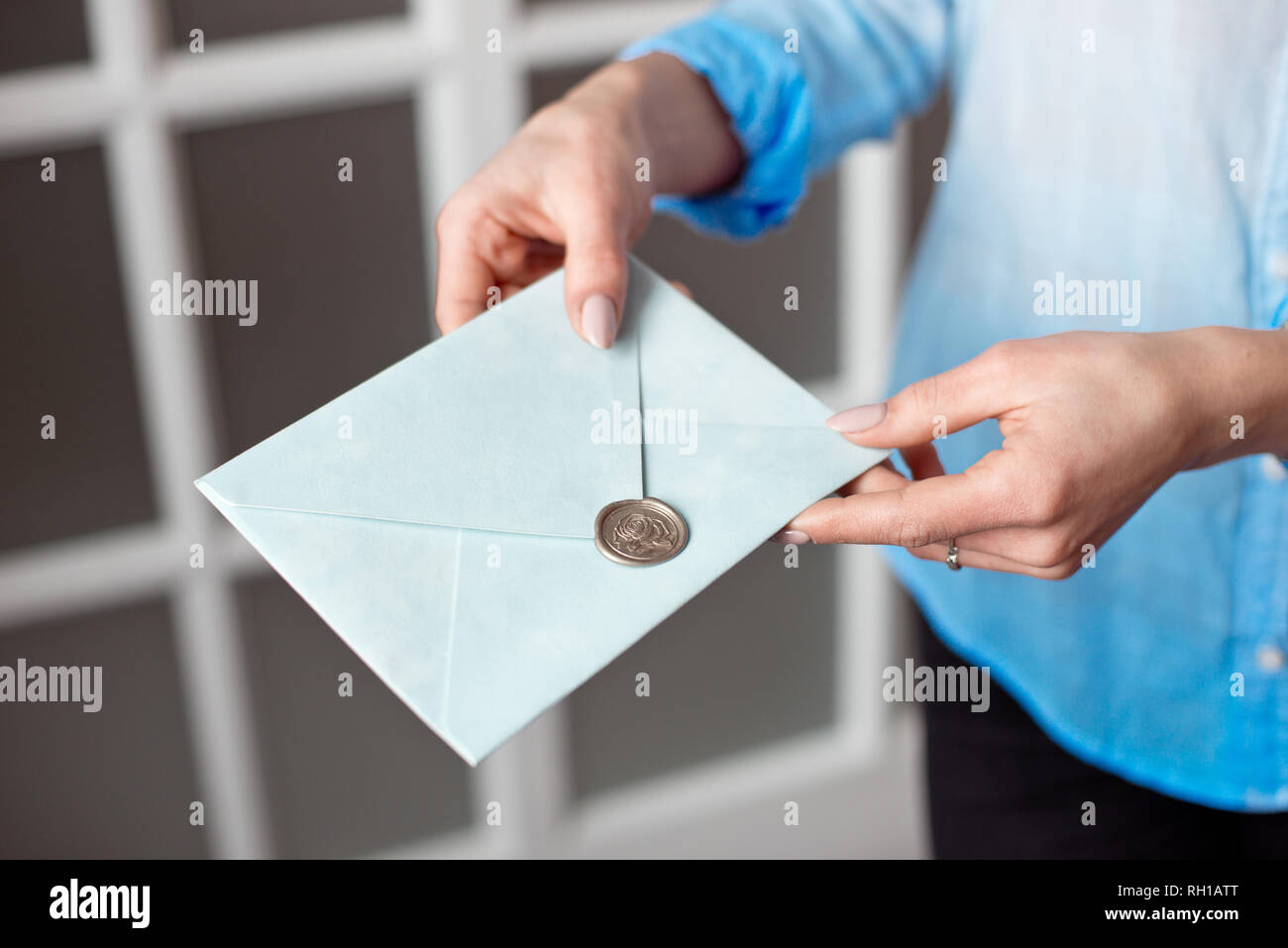Close-up of a woman with a slim body holding a blue rectangular ...