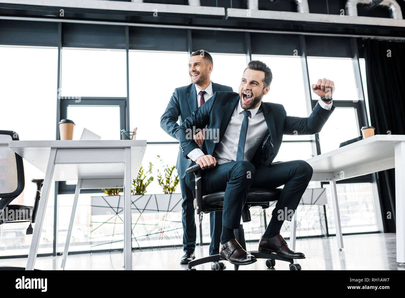 Office chair pushing hi-res stock photography and images - Alamy