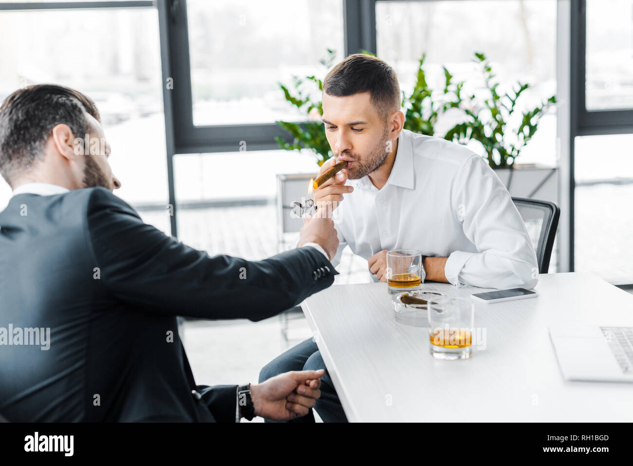 businessman in formal wear smoking cuban cigar in modern office Stock ...