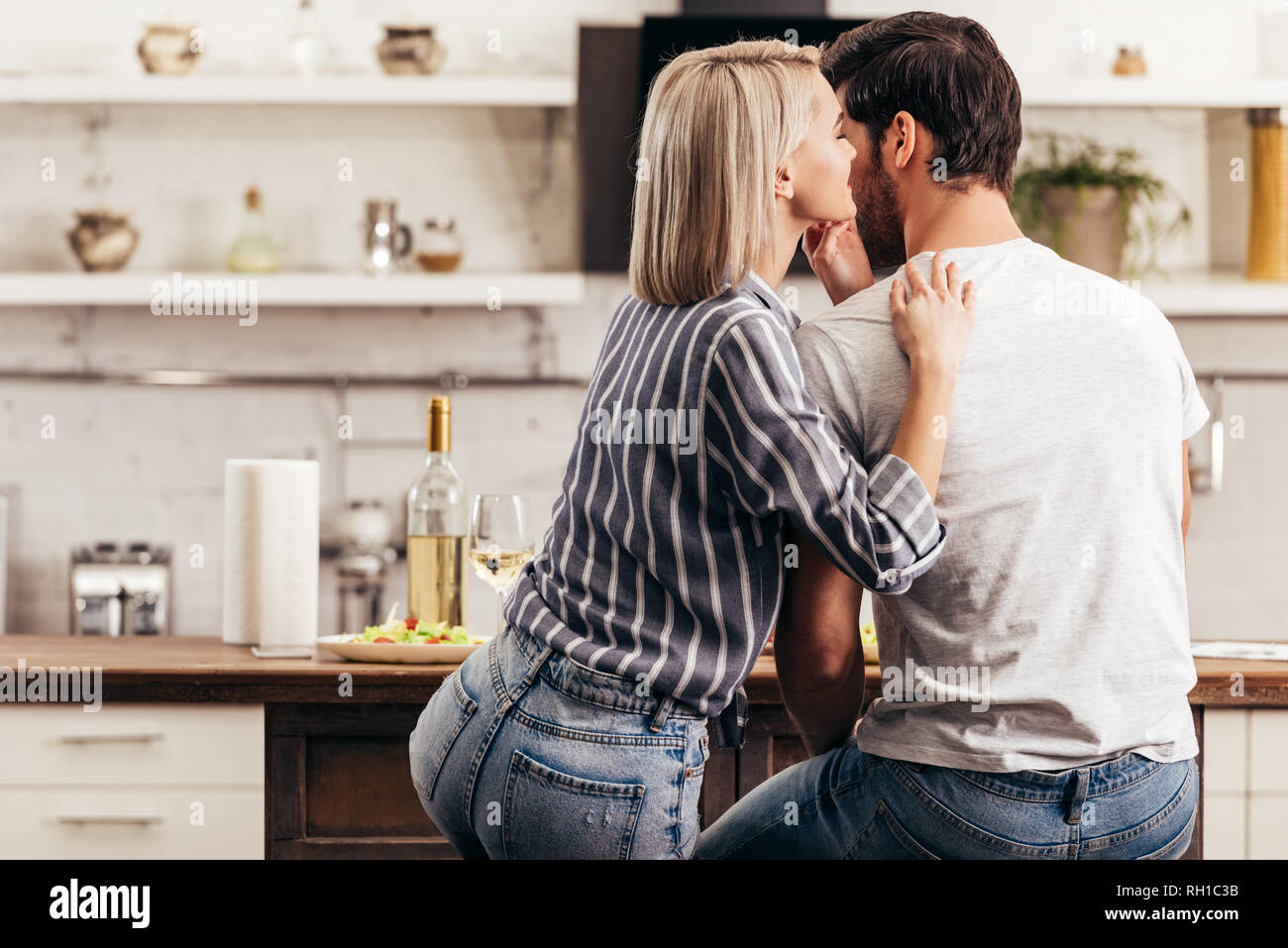 boyfriend and attractive girlfriend hugging in kitchen Stock Photo - Alamy