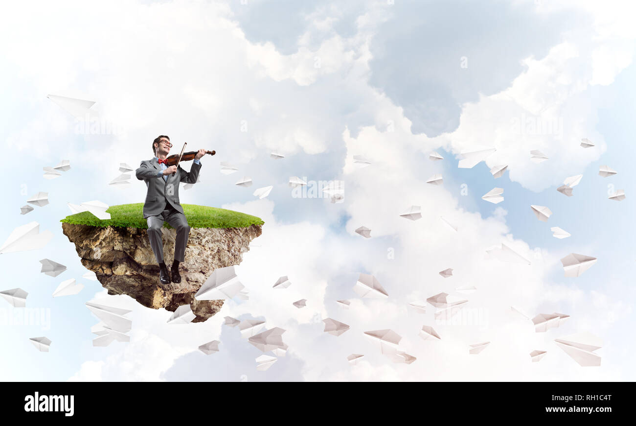 Handsome businessman play his melody and paper planes fly around Stock ...