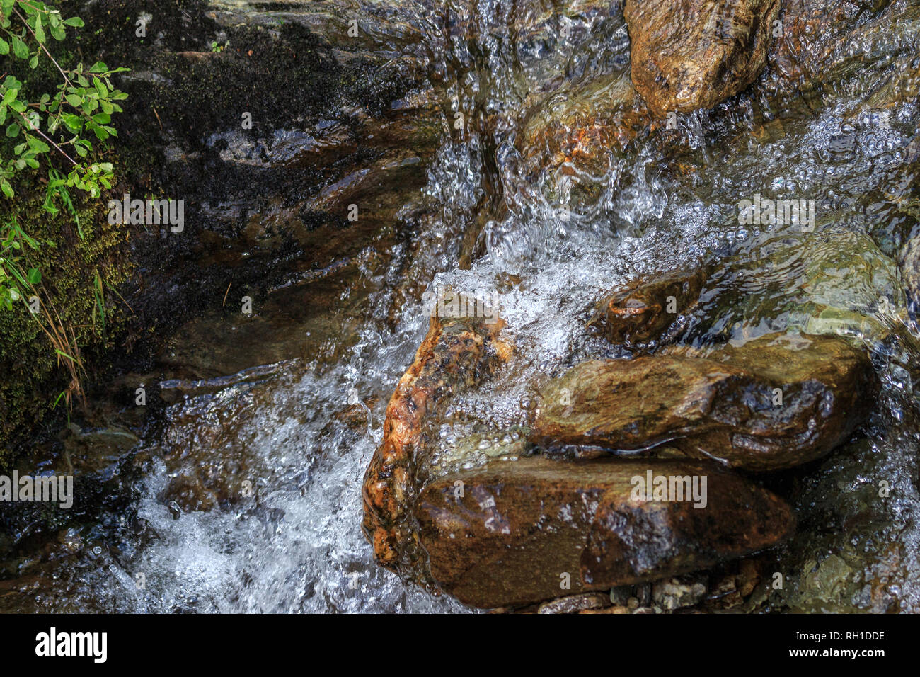 Water tumbling over rocks in small stream Stock Photo - Alamy