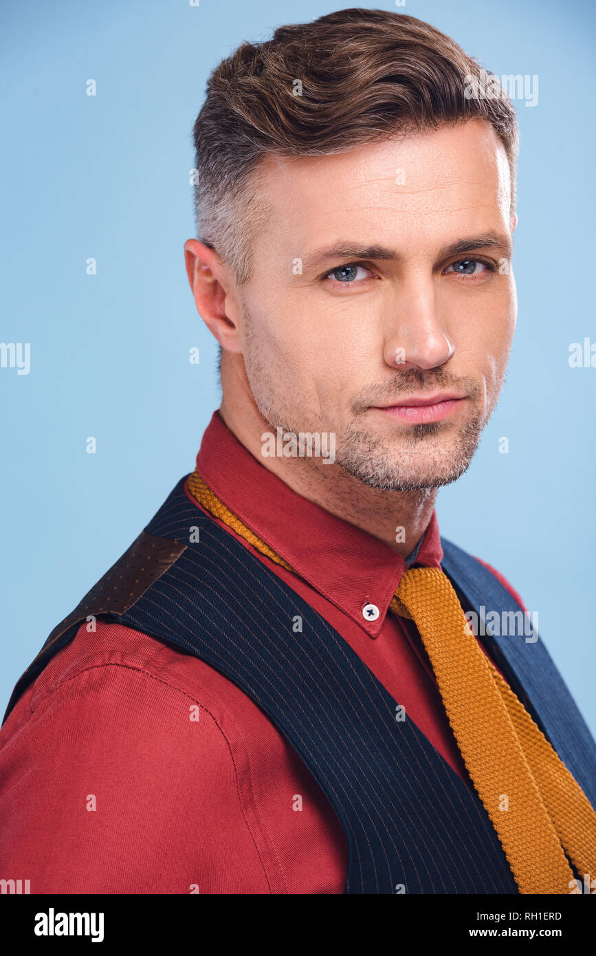 portrait of handsome stylish man in formal wear looking at camera ...
