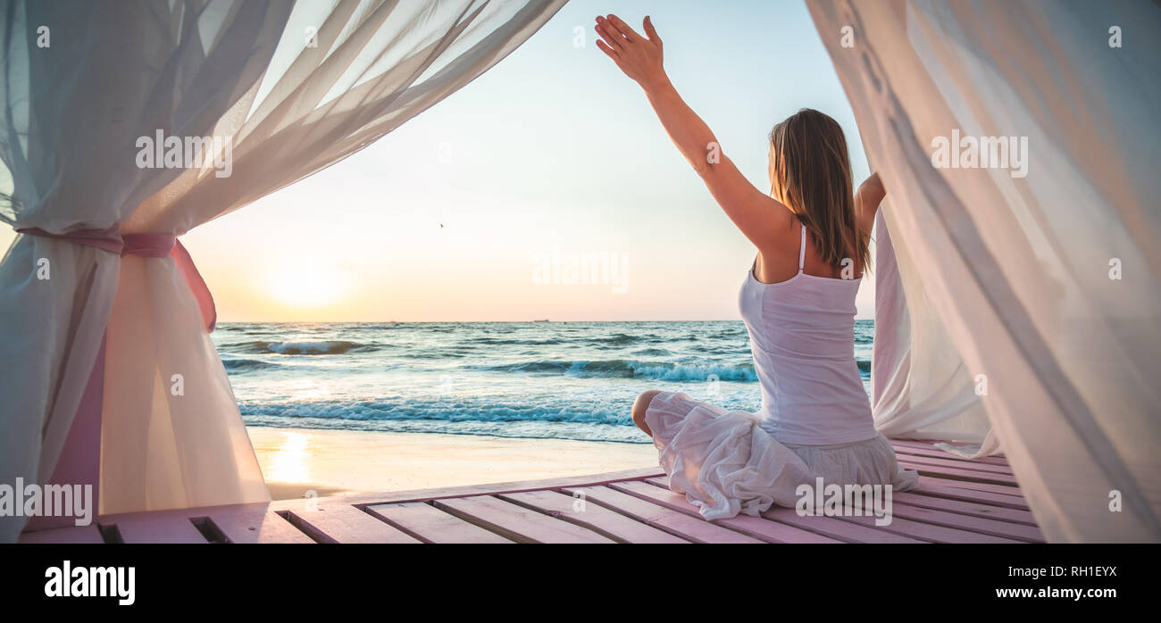 Woman meditating at the sea Stock Photo - Alamy