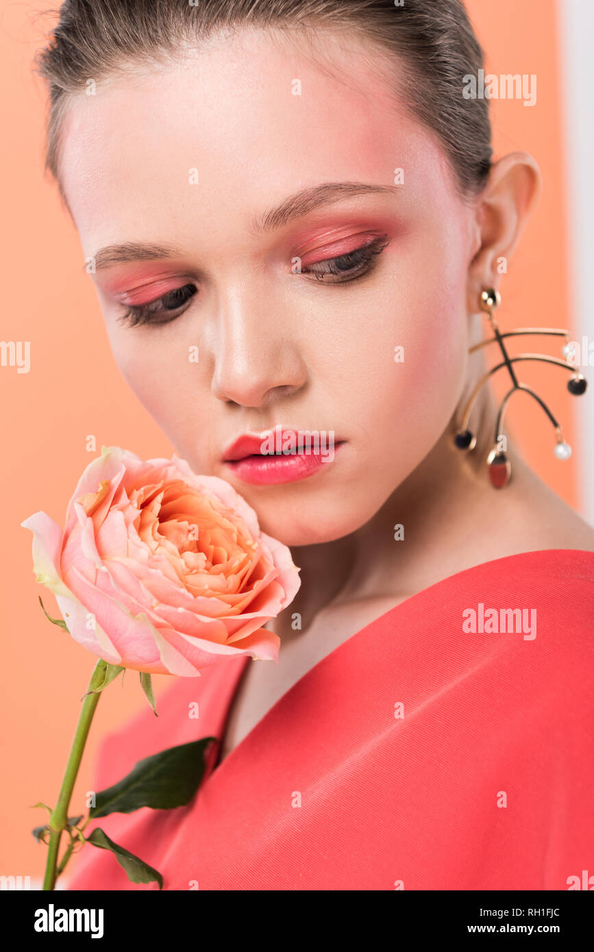 selective focus of beautiful stylish girl holding rose and posing with ...