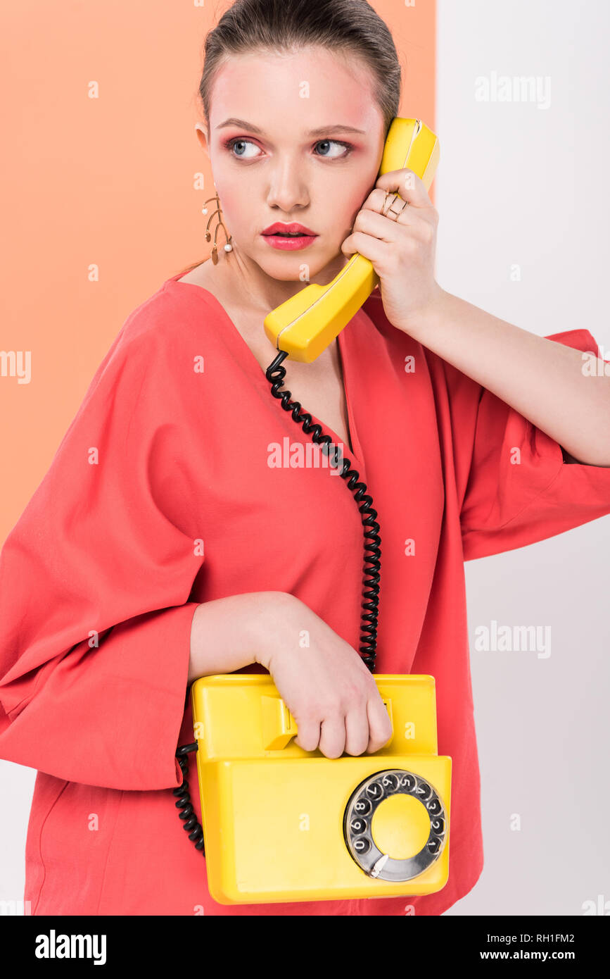 beautiful stylish girl talking on retro telephone and posing with ...