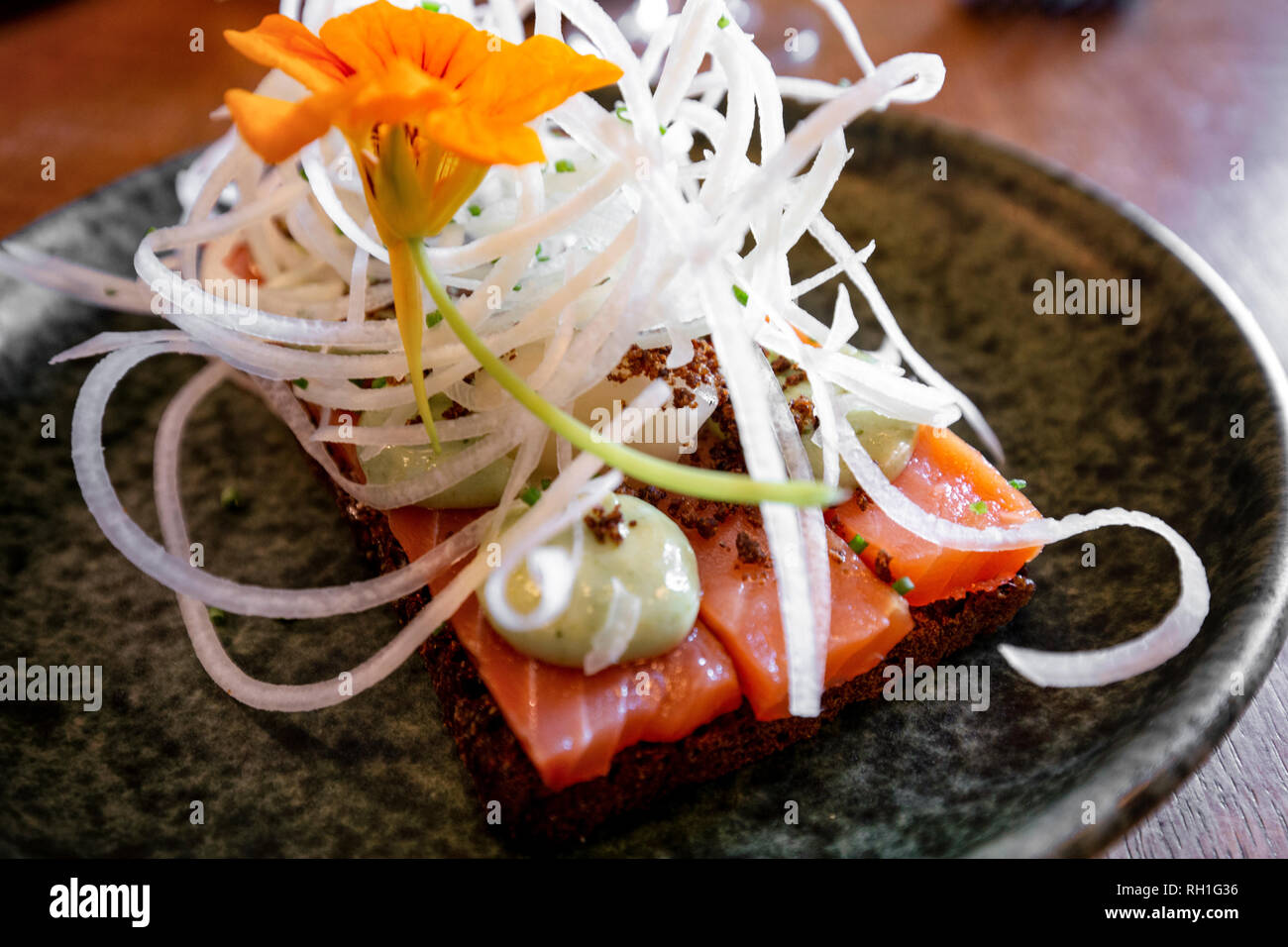 Smorrebrod with salmon, a dish typical of Danish culture Stock Photo ...