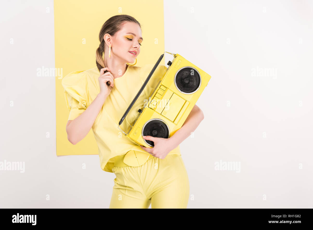 beautiful stylish girl holding retro boombox and posing with limelight ...