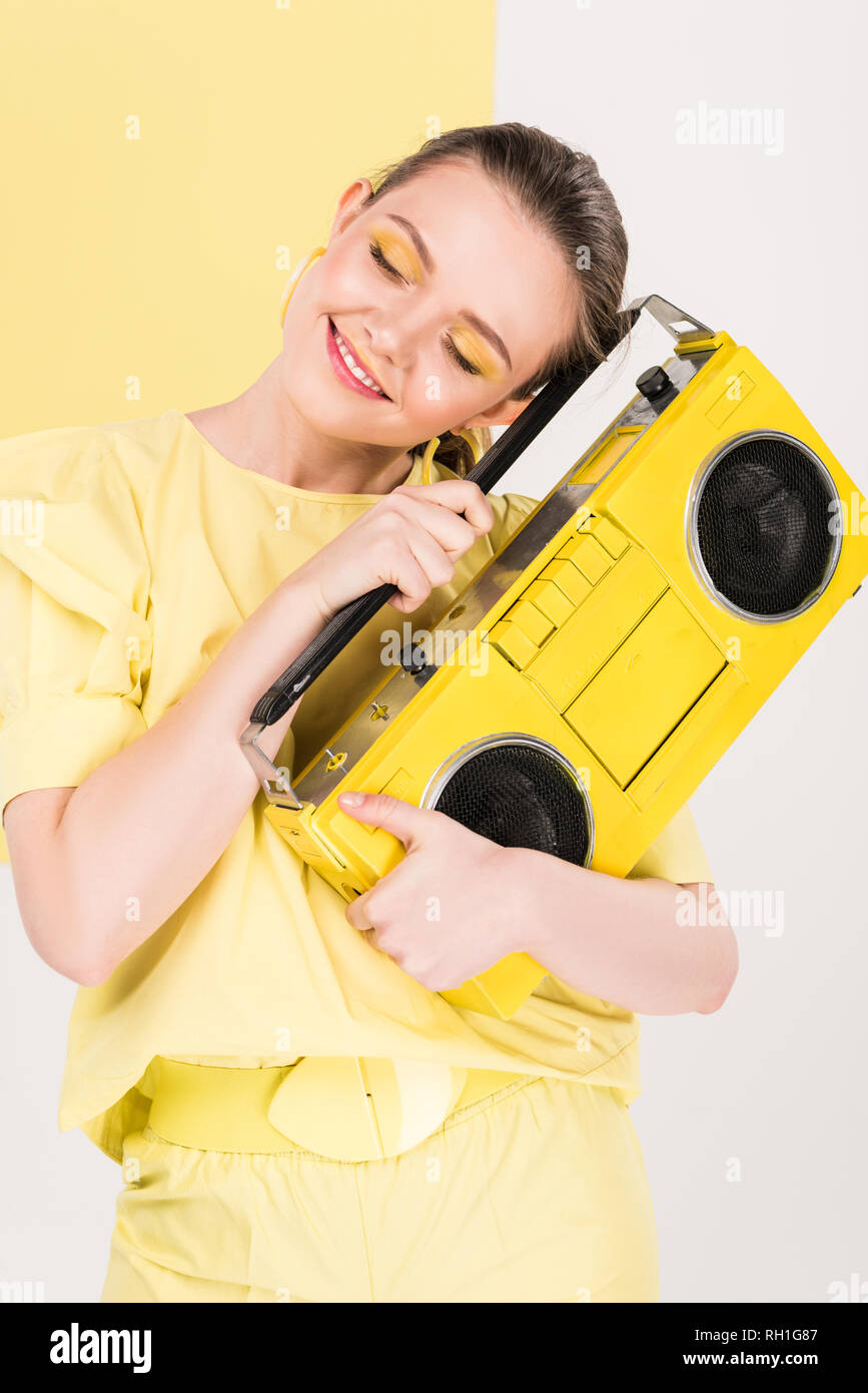 stylish girl holding retro boombox and posing with limelight on ...