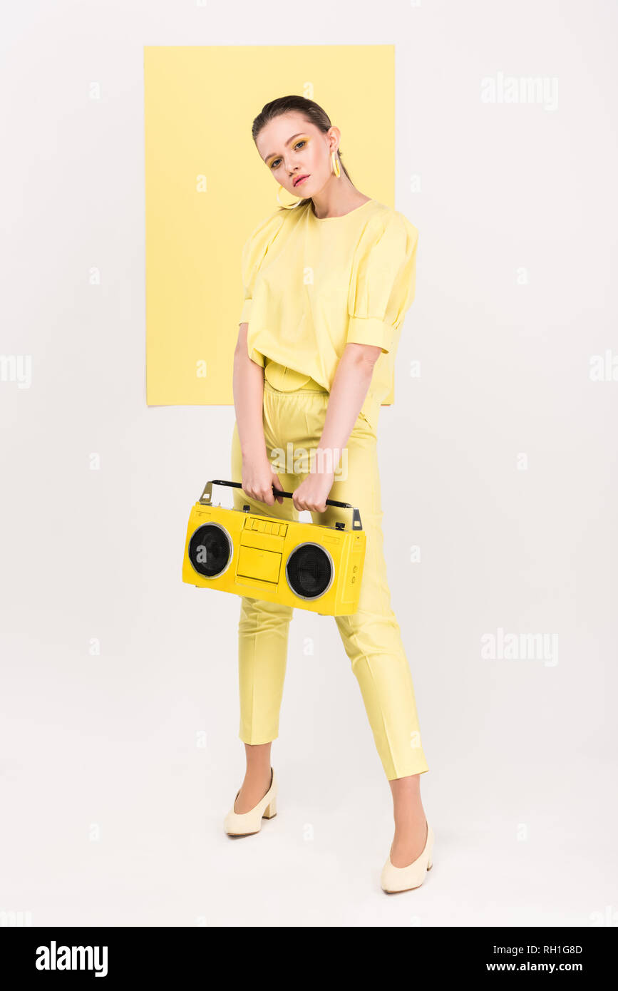 stylish girl holding retro boombox and posing with limelight on ...