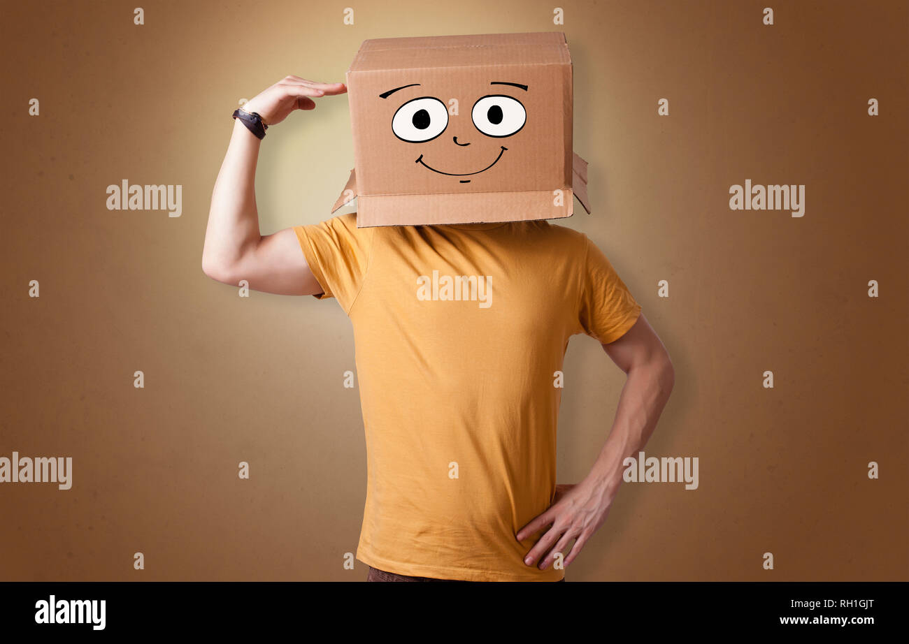 Young boy standing and gesturing with a cardboard box on his head Stock ...