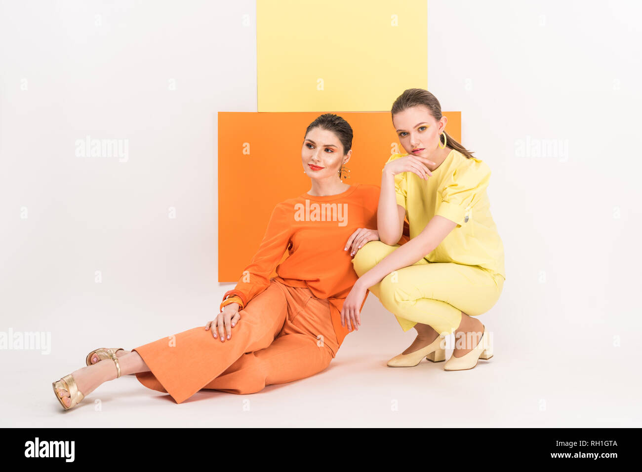 beautiful stylish girls sitting and posing with turmeric and limelight ...