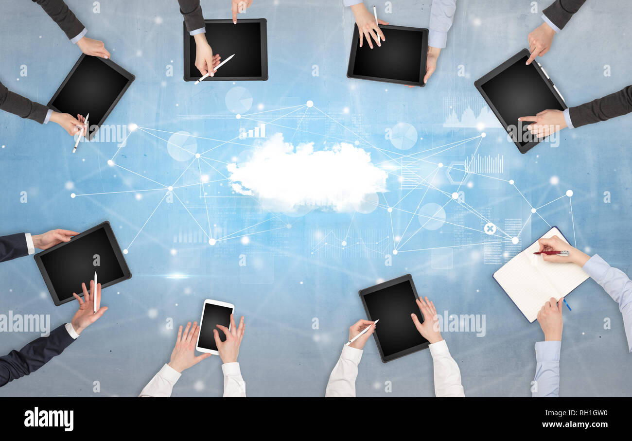 Group of people with devices in hands working on reports with online ...