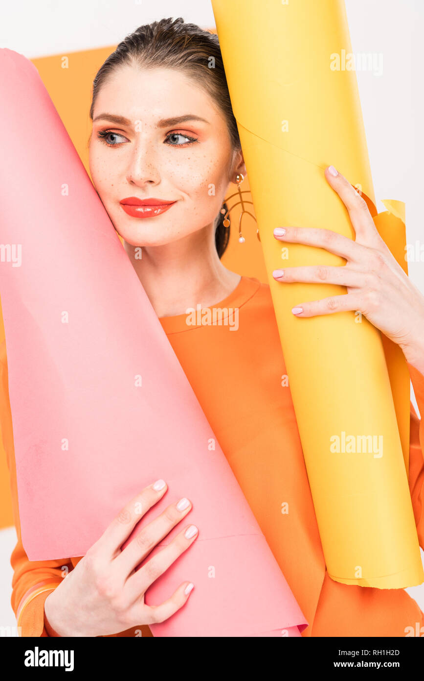 selective focus of stylish young woman in turmeric clothes smiling and ...