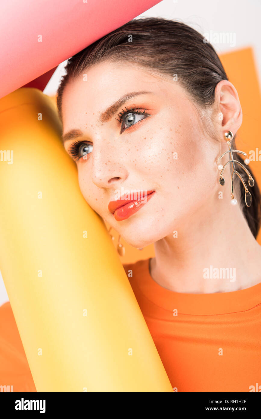 portrait of stylish young woman in turmeric clothes posing with ...