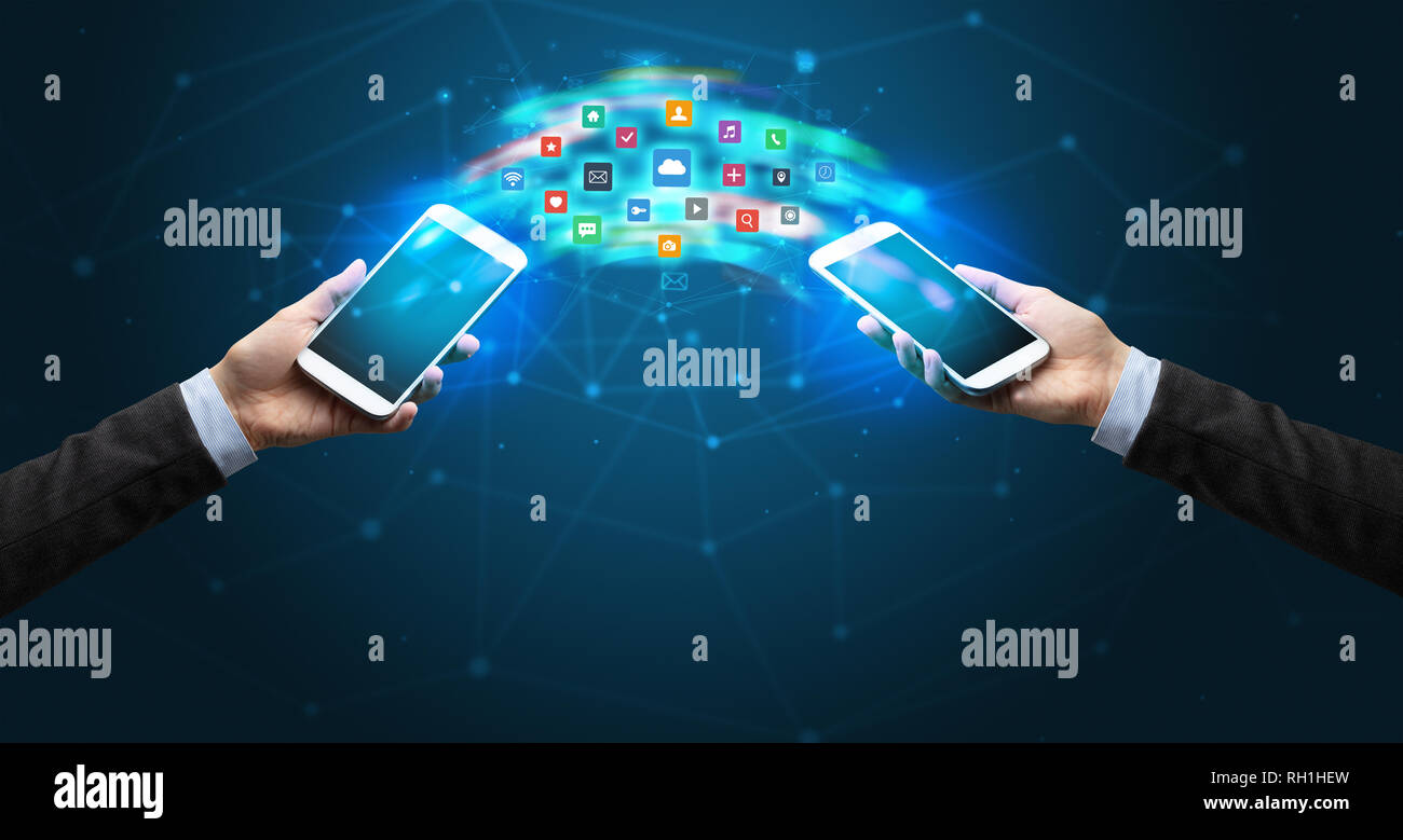 Two mobile phones syncing applications concept Stock Photo - Alamy