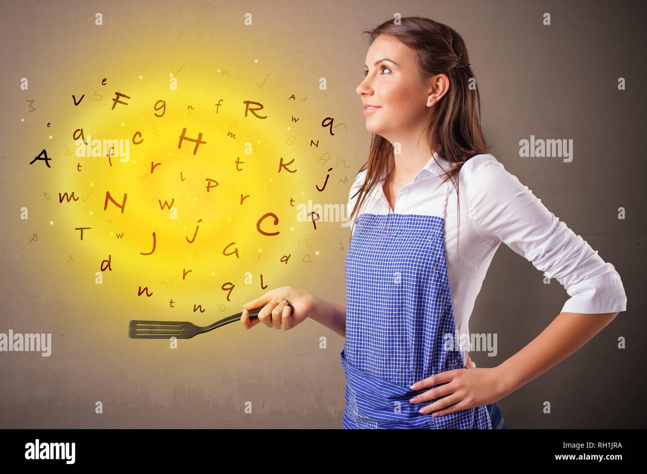 Young person cooking letters in wok Stock Photo - Alamy