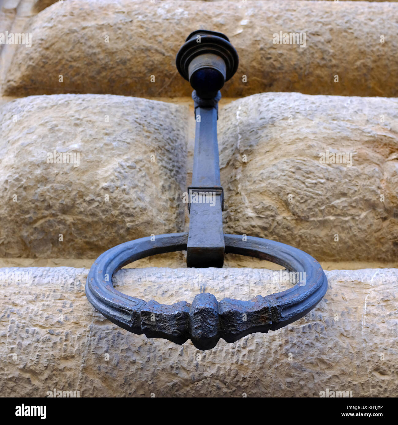 Metal Iron Horse Hitching Post against old stone walls Florence Italy ...