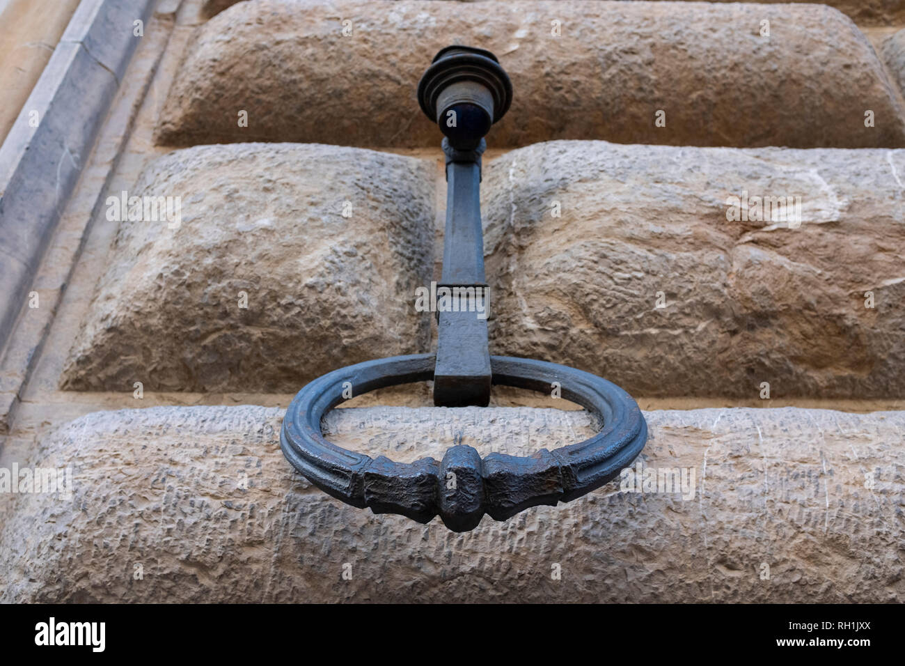 Metal Iron Horse Hitching Post against old stone walls Florence Italy ...