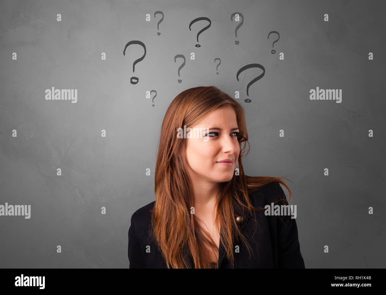 Person with question marks around face Stock Photo - Alamy