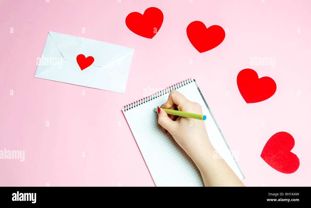 Female hand writing a love letter. Valentines day concept. Greeting ...