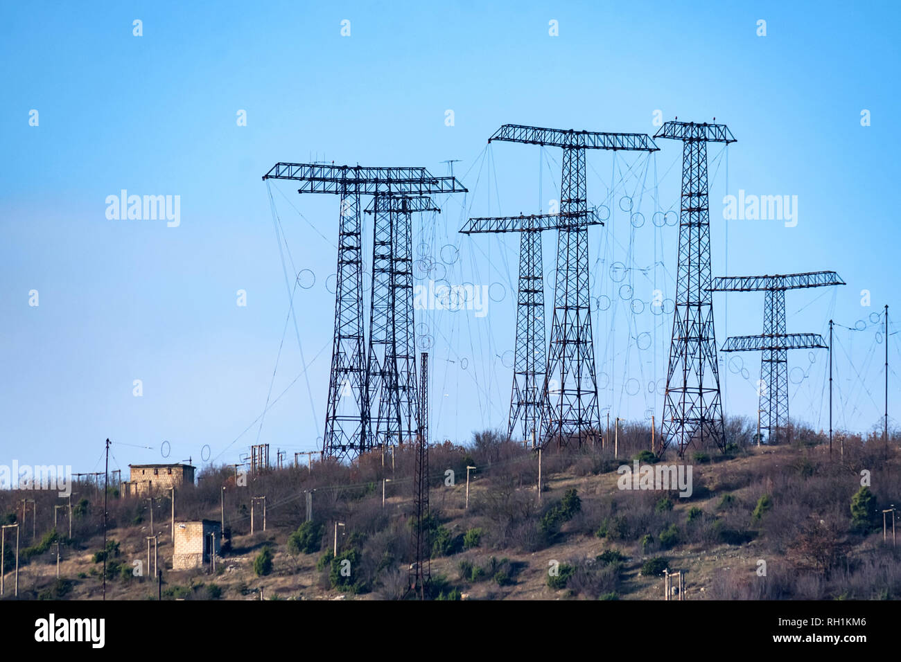 Hill with a lot of power towers at electric power station Stock Photo ...