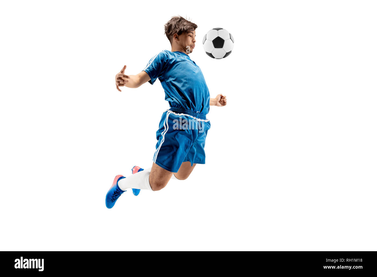Young boy with soccer ball doing flying kick, isolated on white ...