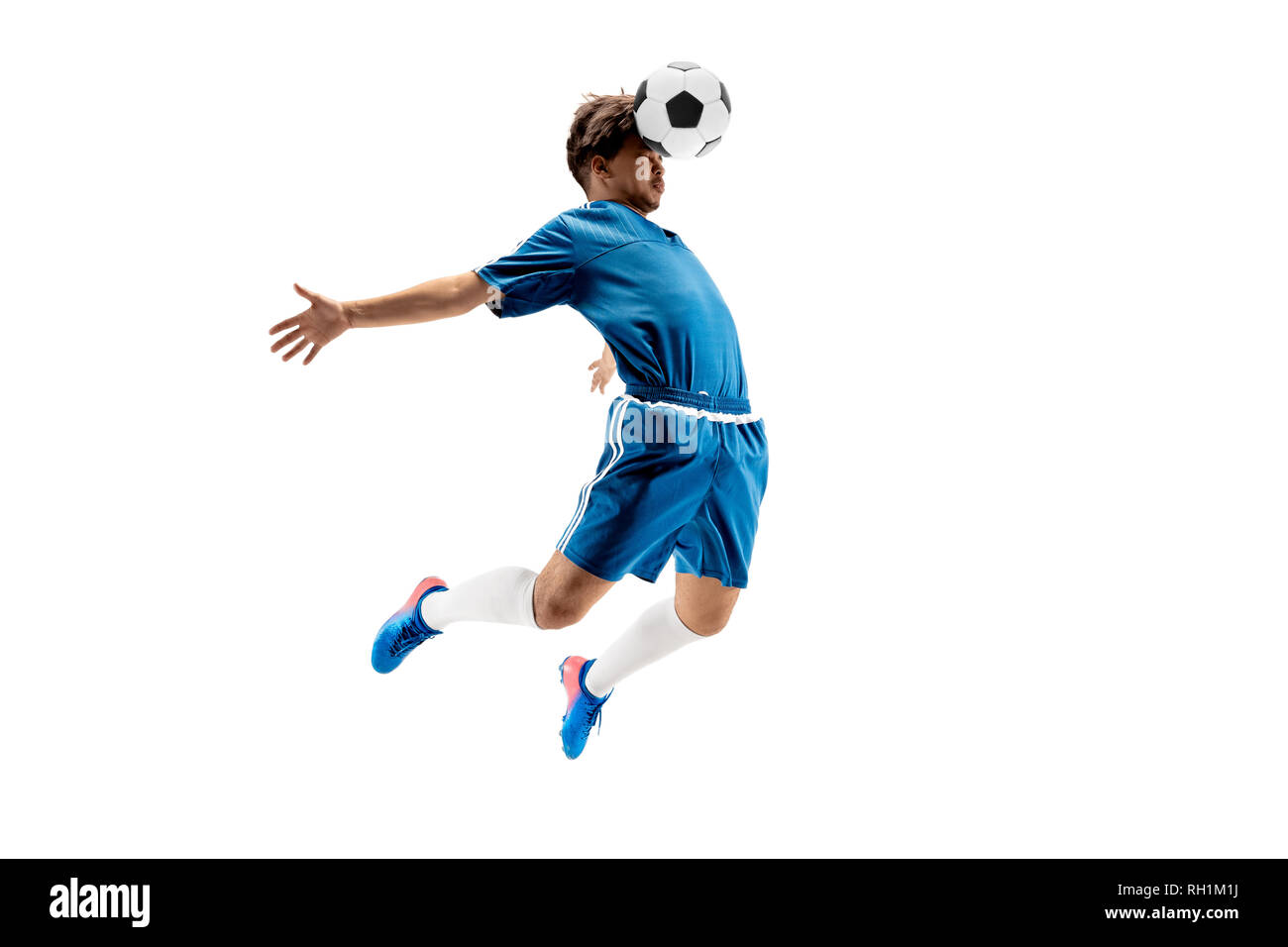 Young boy with soccer ball doing flying kick, isolated on white ...
