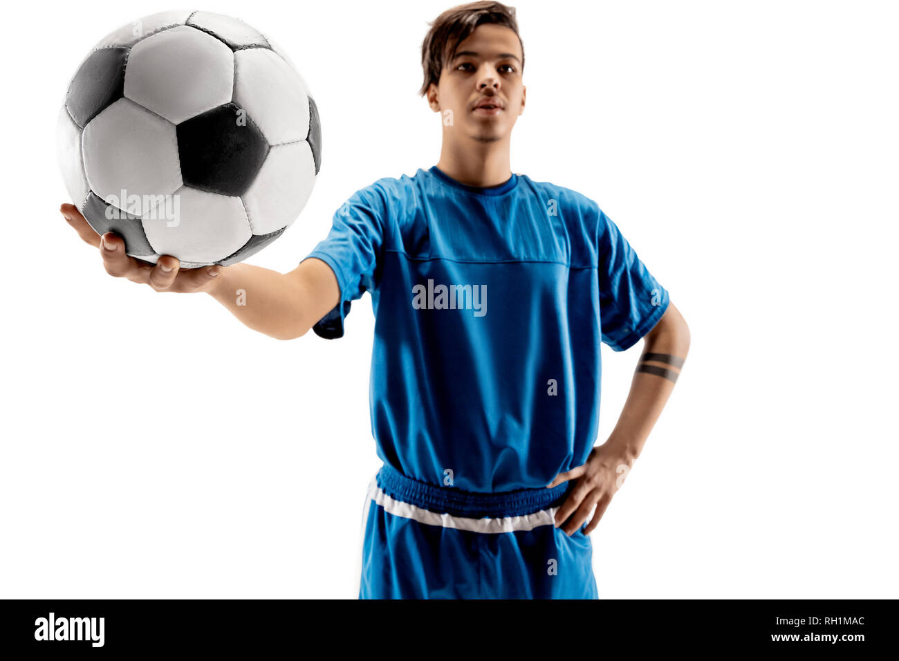 Young fit boy with soccer ball standing isolated on white as winner ...