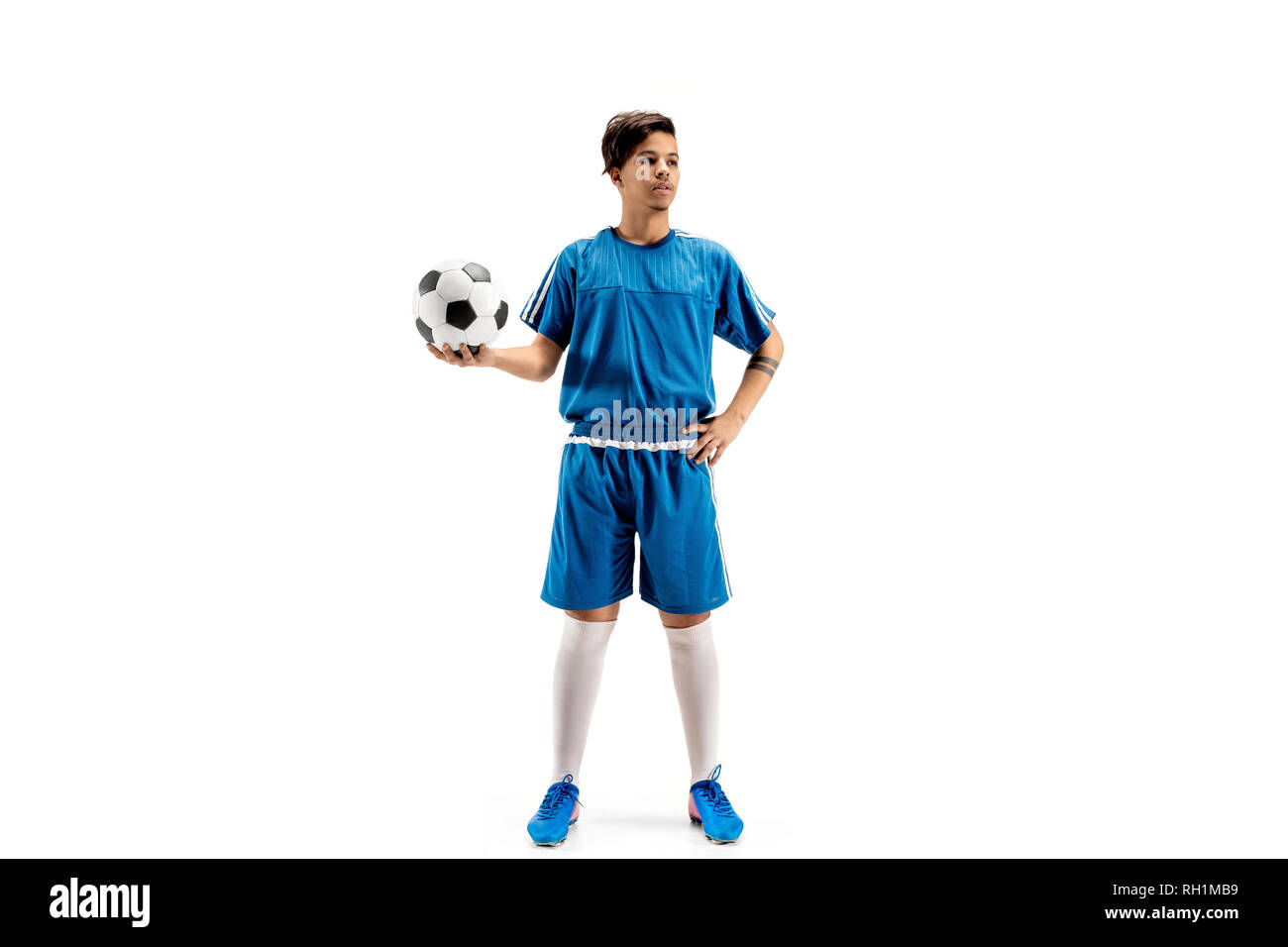 Young fit boy with soccer ball standing isolated on white as winner ...