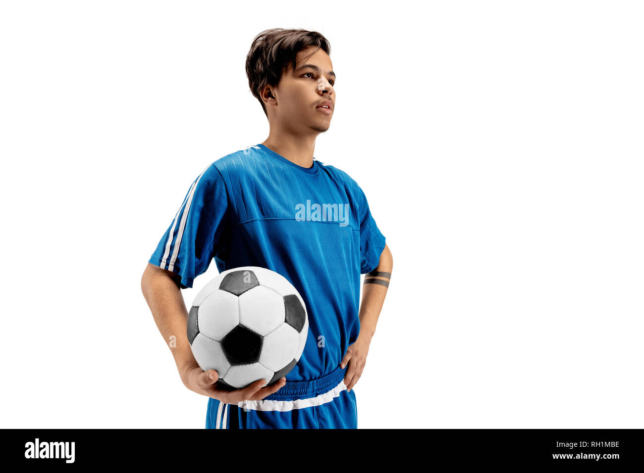 Young fit boy with soccer ball standing isolated on white as winner ...