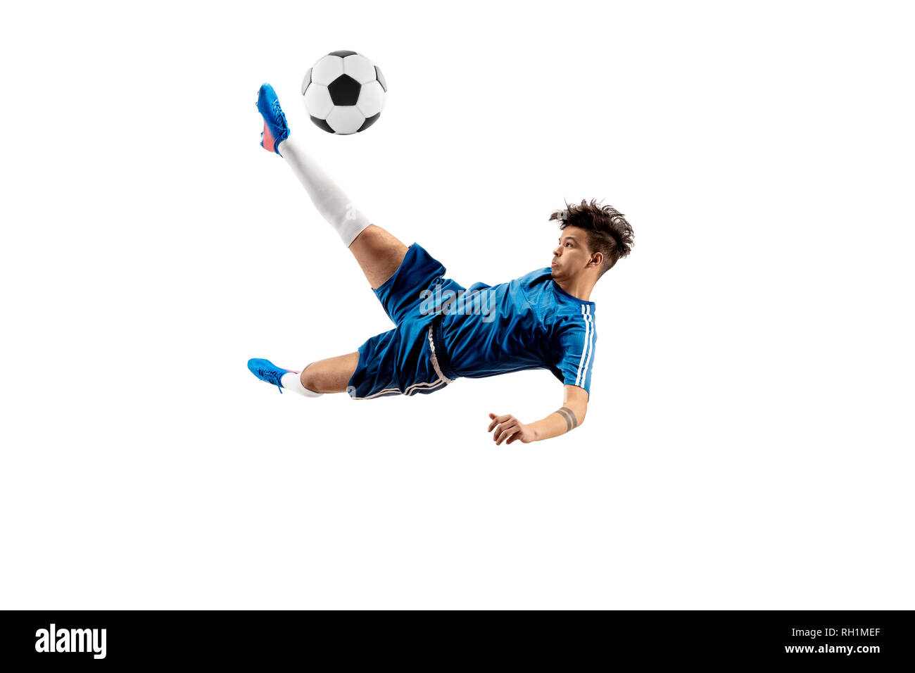 Young boy with soccer ball doing flying kick, isolated on white ...