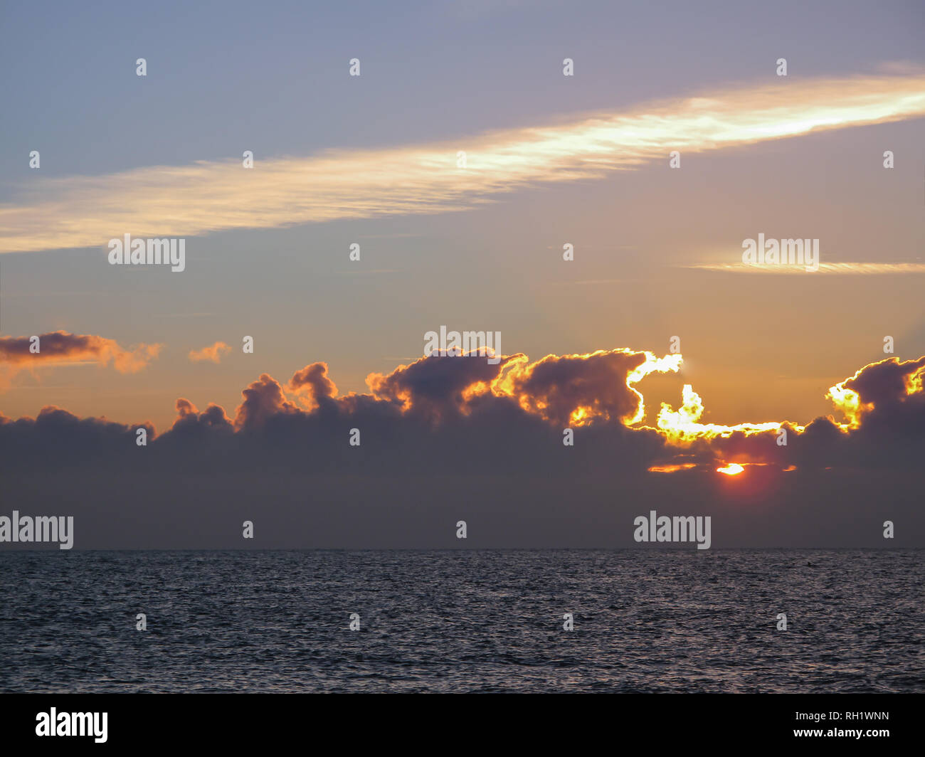 Sun rising behind clouds on the stunningly beautiful Cornwall Coast Stock Photo - Alamy