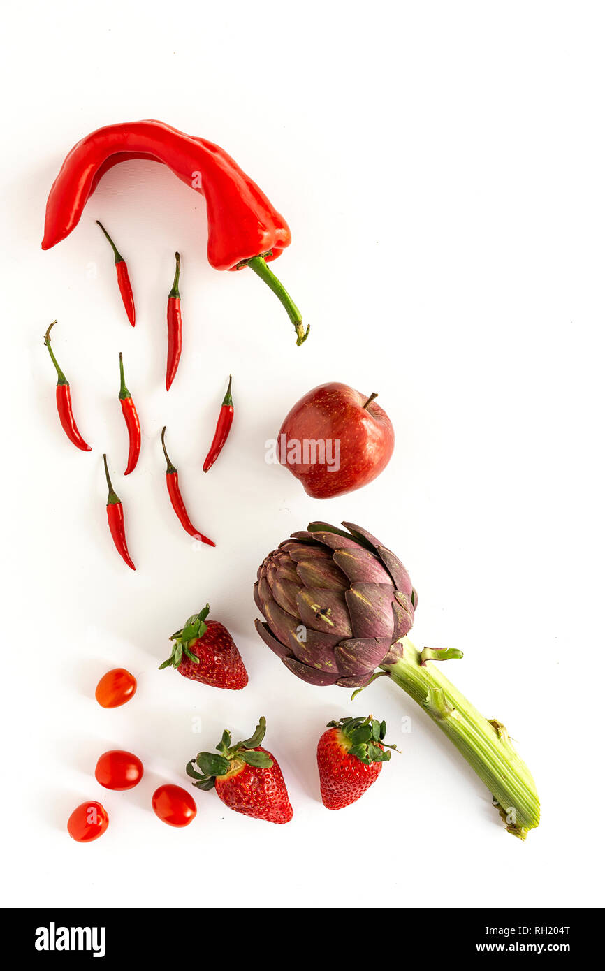 Mix of fruits and vegetables in red color on white background. Healthy ...