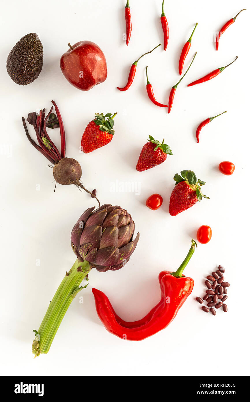 Mix of fruits and vegetables in red color on white background. Healthy ...